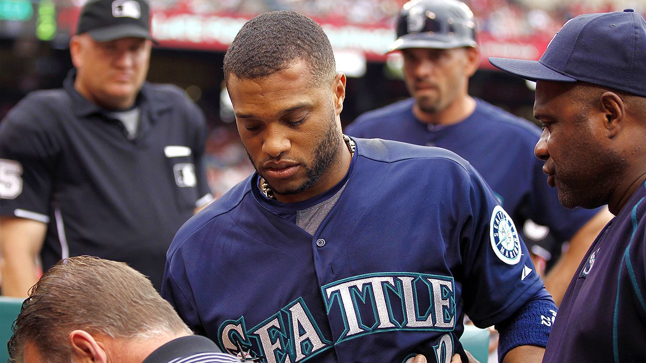 Robinson Cano of Seattle Mariners hit in head by stray ball during Angels' warm-ups, exits with ...